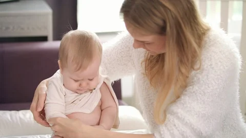 Mother change clothes to her baby. Cute ... | Stock Video | Pond5