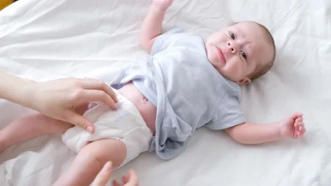 Mother changes diapers to her newborn ba... | Stock Video | Pond5