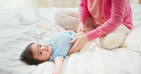 Mother changing baby diaper | Stock Video | Pond5