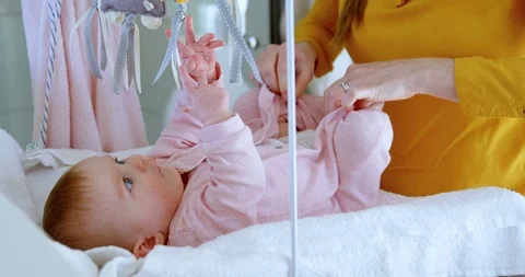 Mother changing diaper of her baby boy 4... | Stock Video | Pond5