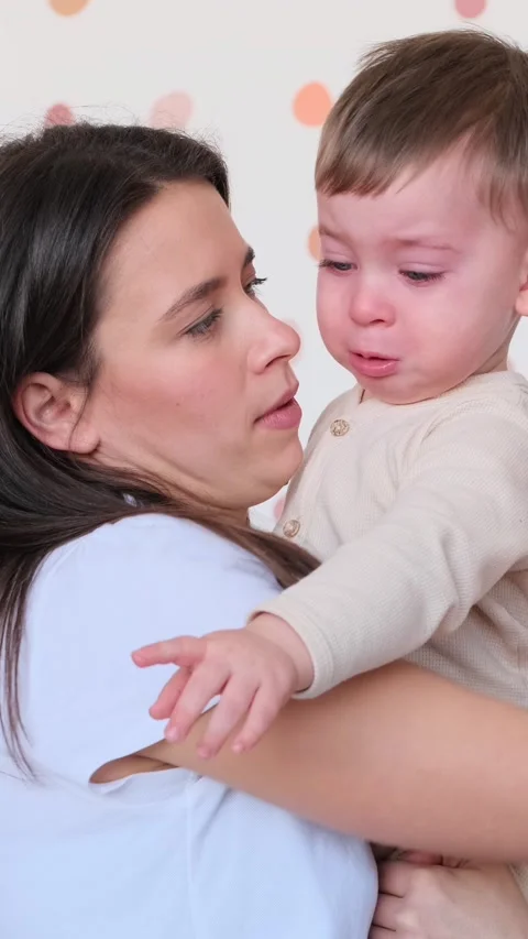 Mother Comforting Crying Baby Boy At Hom... | Stock Video | Pond5