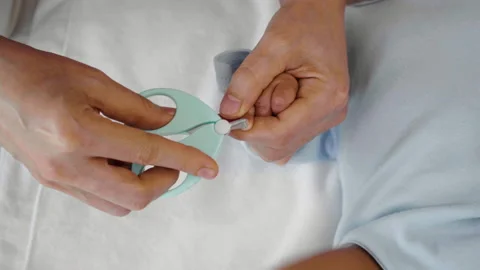 mother cutting newborn baby's hand finge... | Stock Video | Pond5