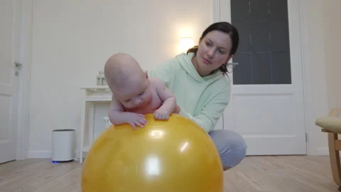 Mother doing exercise with baby boy on f... | Stock Video | Pond5