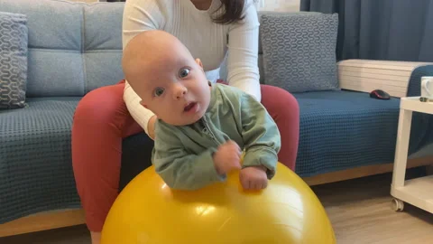 Mother doing exercise with infant on fit... | Stock Video | Pond5