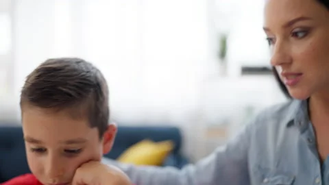 Mother explaining her son how to do home... | Stock Video | Pond5