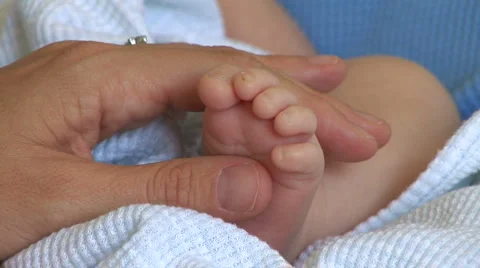 Mother holding newborn baby feet and toe... | Stock Video | Pond5