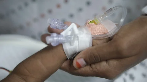 mother-holding-sick-newborn-baby-hand | Stock Video | Pond5