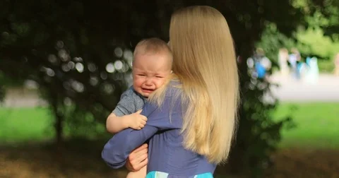 Mother hugging crying son park calm smoo... | Stock Video | Pond5