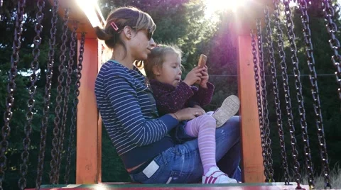 Mother with little child girl sit park p... | Stock Video | Pond5