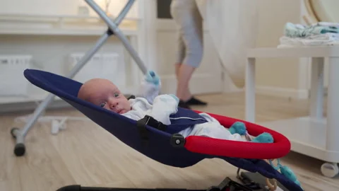 Mother with newborn baby boy in rocking ... | Stock Video | Pond5