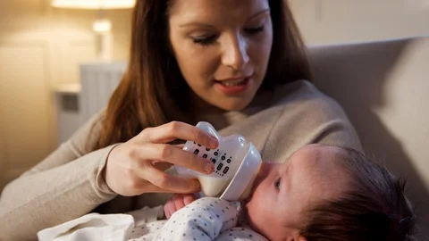 Mother In Nursery Feeding Newborn Baby F... | Stock Video | Pond5