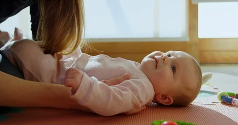 Mother picking up her baby boy at home 4... | Stock Video | Pond5
