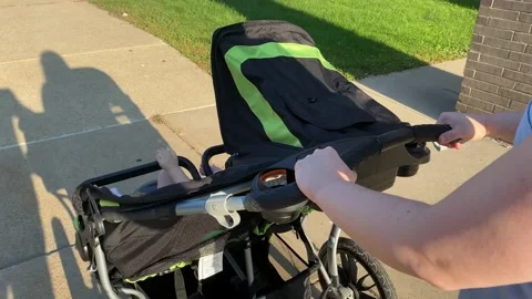 Mother pushing brother and sister in dou... | Stock Video | Pond5