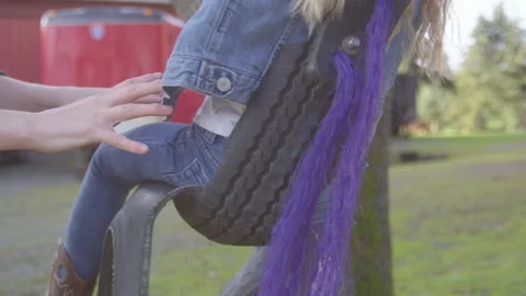 Mother Pushing Daughter on a Rope Swing ... | Stock Video | Pond5