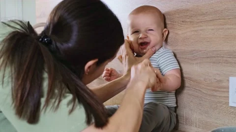 Mother rescuing child from choke with bi... | Stock Video | Pond5