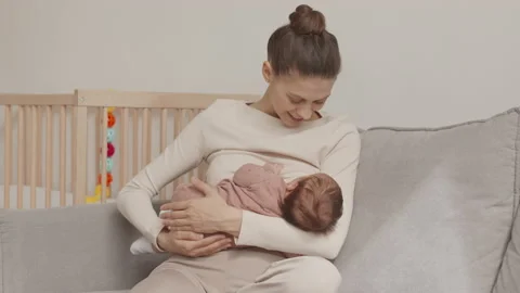 Mother Rocking Newborn Baby to Sleep at ... | Stock Video | Pond5