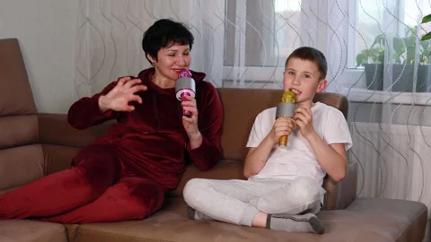 Mother singing with son using microphone... | Stock Video | Pond5