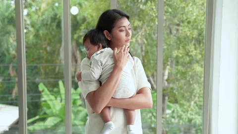 mother stands holding a child. To lull h... | Stock Video | Pond5