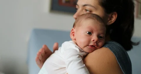 Mother tapping newborn baby back to help... | Stock Video | Pond5