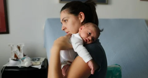 Mother tapping newborn baby back to help... | Stock Video | Pond5