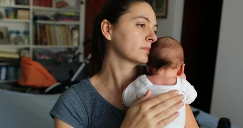 Mother tapping newborn baby back to help... | Stock Video | Pond5