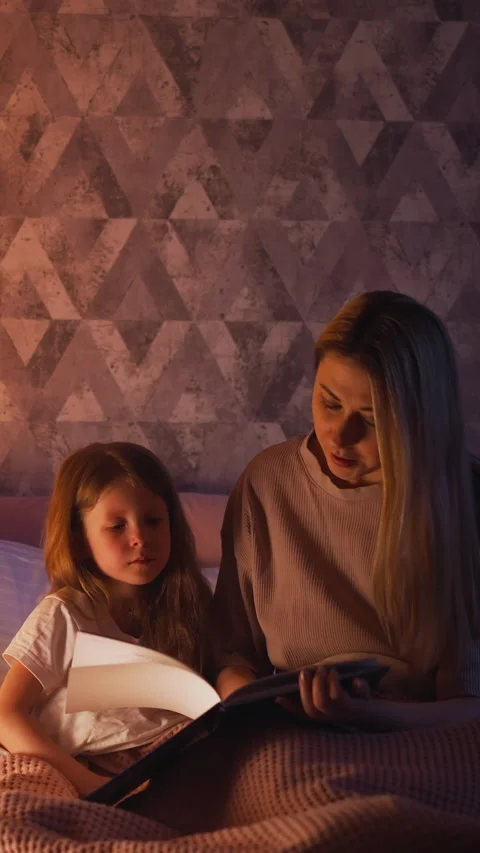Mother turns page reading fairy tale to ... | Stock Video | Pond5