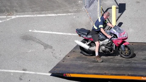 Motion of motorcycle is being offloaded ... | Stock Video | Pond5