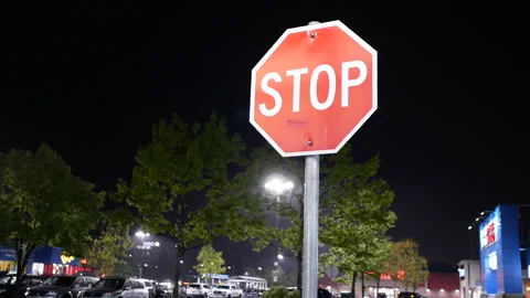 Motion of stop sign in front of parking ... | Stock Video | Pond5