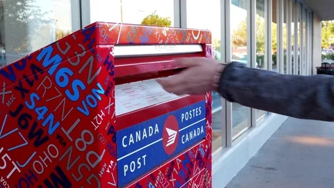 Motion of woman placing mail in a canadi... | Stock Video | Pond5