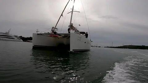 A motor boat crosses the road to a saili... | Stock Video | Pond5