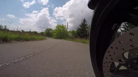 motorcycle front wheel taking corners on... | Stock Video | Pond5
