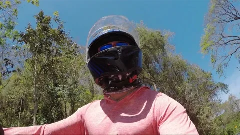 Motorcycle rider with helmet on, driving... | Stock Video | Pond5