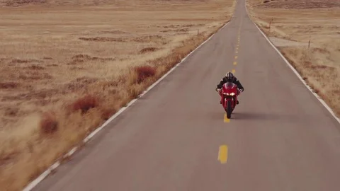 Motorcyclist riding his motorcycle down ... | Stock Video | Pond5