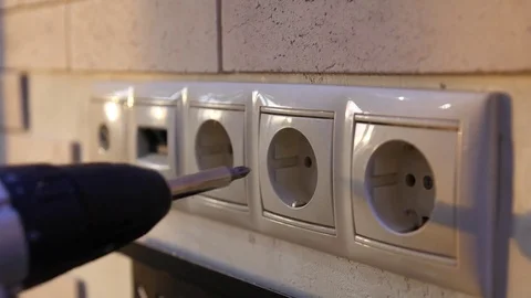 Mounting the electrical socket with a sc... | Stock Video | Pond5