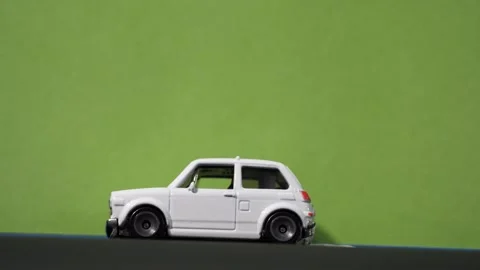 Moving wheels on a toy car with green sc... | Stock Video | Pond5