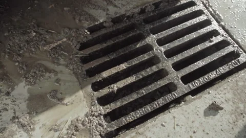 Muddy water going into stormwater drain | Stock Video | Pond5