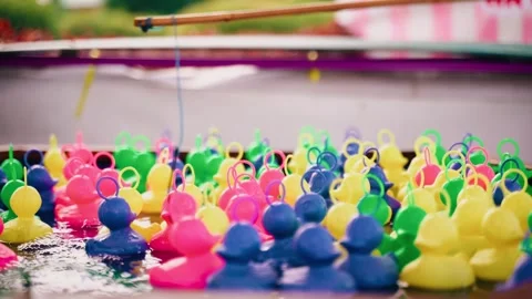 Multi-colored plastic ducks swim in the ... | Stock Video | Pond5
