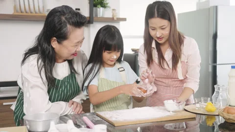 multi-generational family baking togethe... | Stock Video | Pond5