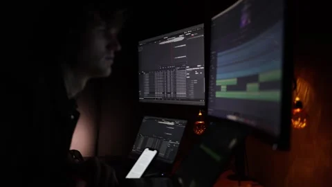 A multi-monitor setup in a dimly lit roo... | Stock Video | Pond5