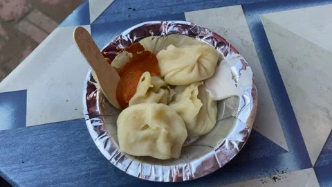 Multiple Momo being served in a paper pl... | Stock Video | Pond5