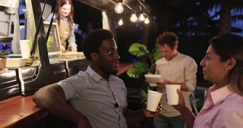 Multiracial people talking in front of f... | Stock Video | Pond5