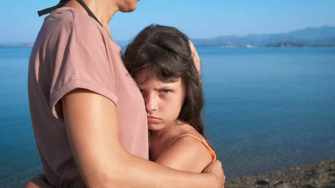 Mum hug sad child on beach. | Stock Video | Pond5