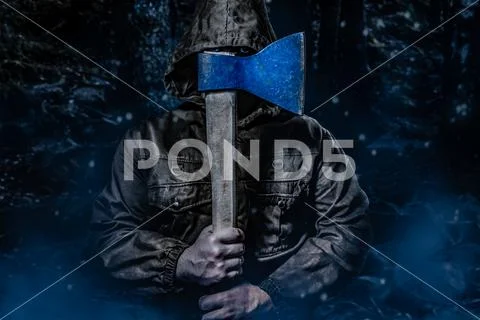 Murderer with an axe in dark woods. ~ Premium Photo #149376614