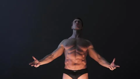 A muscular athlete in an epic pose, fog ... | Stock Video | Pond5