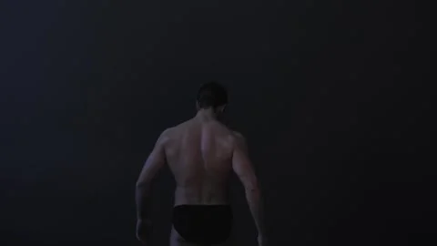 A muscular athlete in an epic pose, fog ... | Stock Video | Pond5