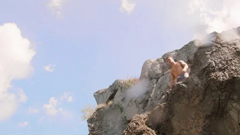 Muscular Man Cliff Jumping Slow Motion U... | Stock Video | Pond5