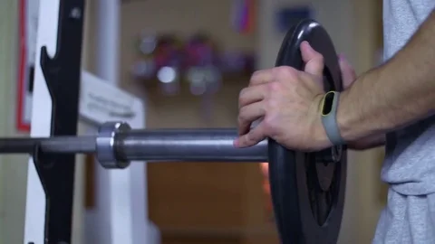 muscular man putting heavy plates on bar... | Stock Video | Pond5