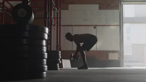 Muscular Man Trains with Weights in a Gy... | Stock Video | Pond5