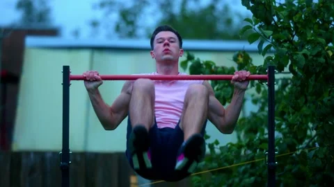 A Muscular Young Man Doing Pull-Ups Exer... | Stock Video | Pond5