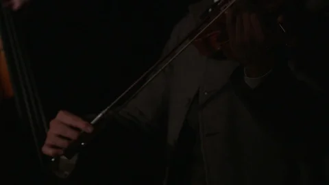 Musicians playing in darkness - Titanic,... | Stock Video | Pond5